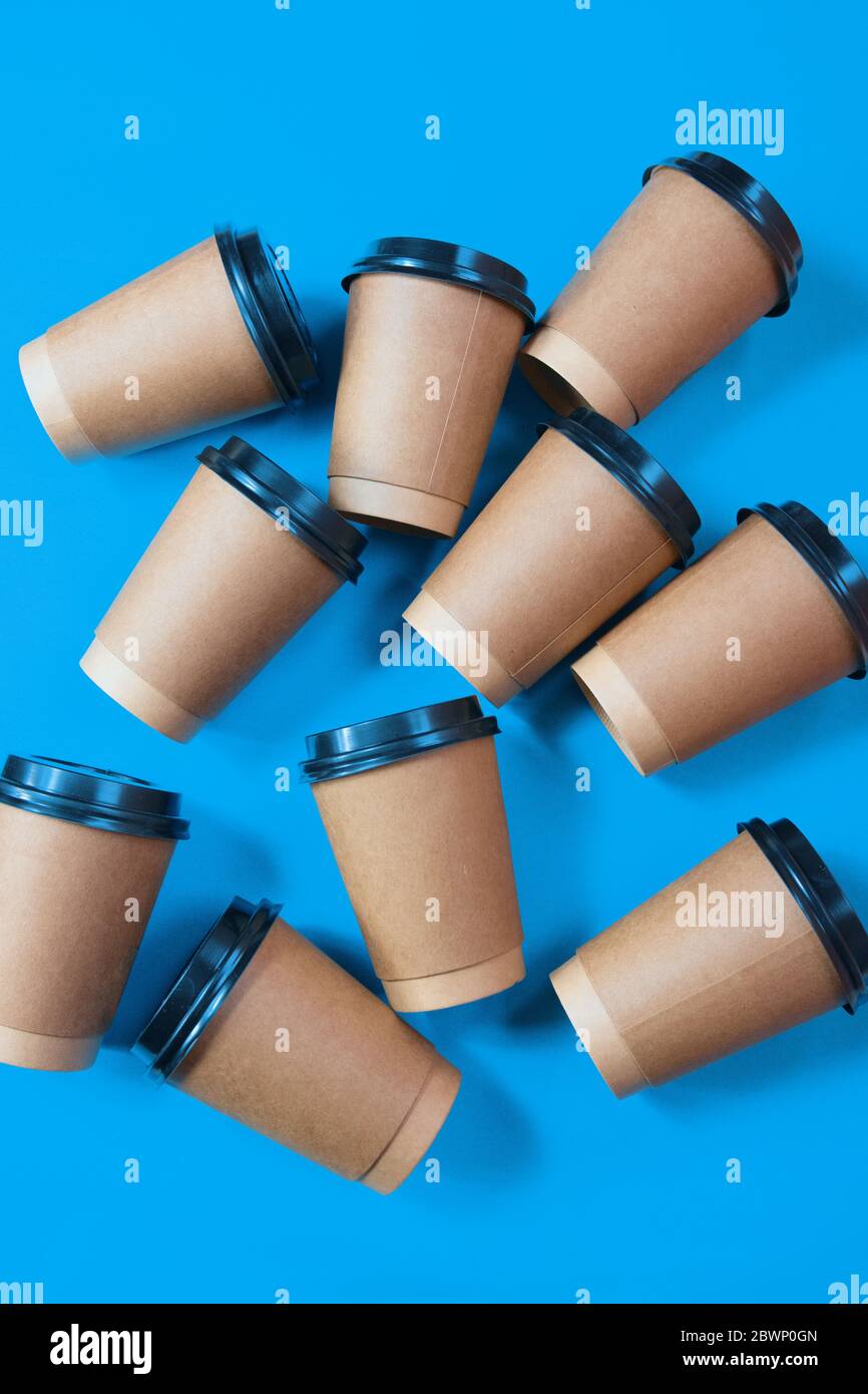 Stylish reusable eco coffee cup and multiple single use cardboard cups ...