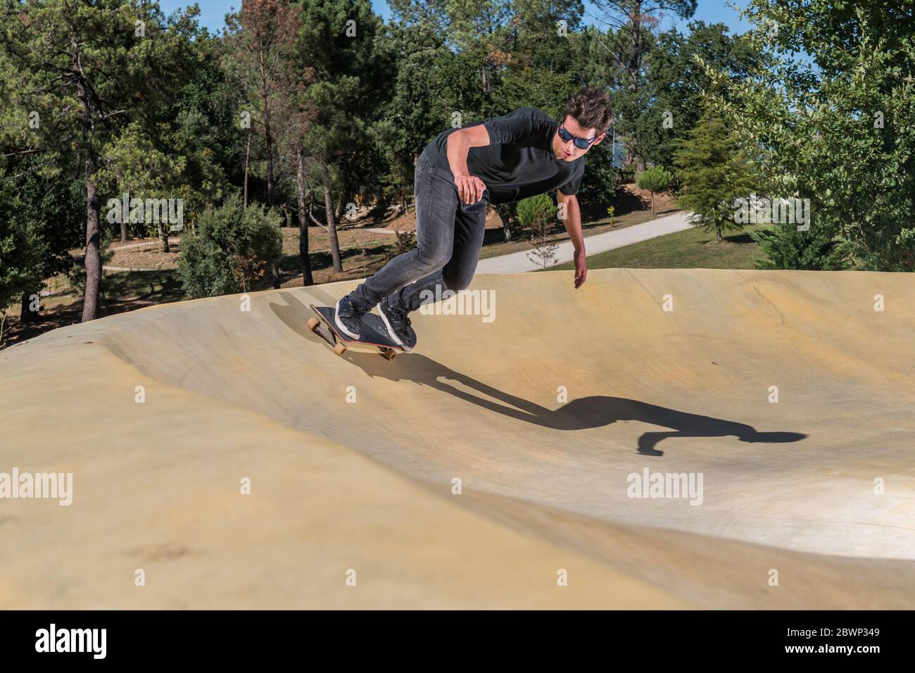 Skateboarder practice on a pump track park on a sunny summer day Stock ...