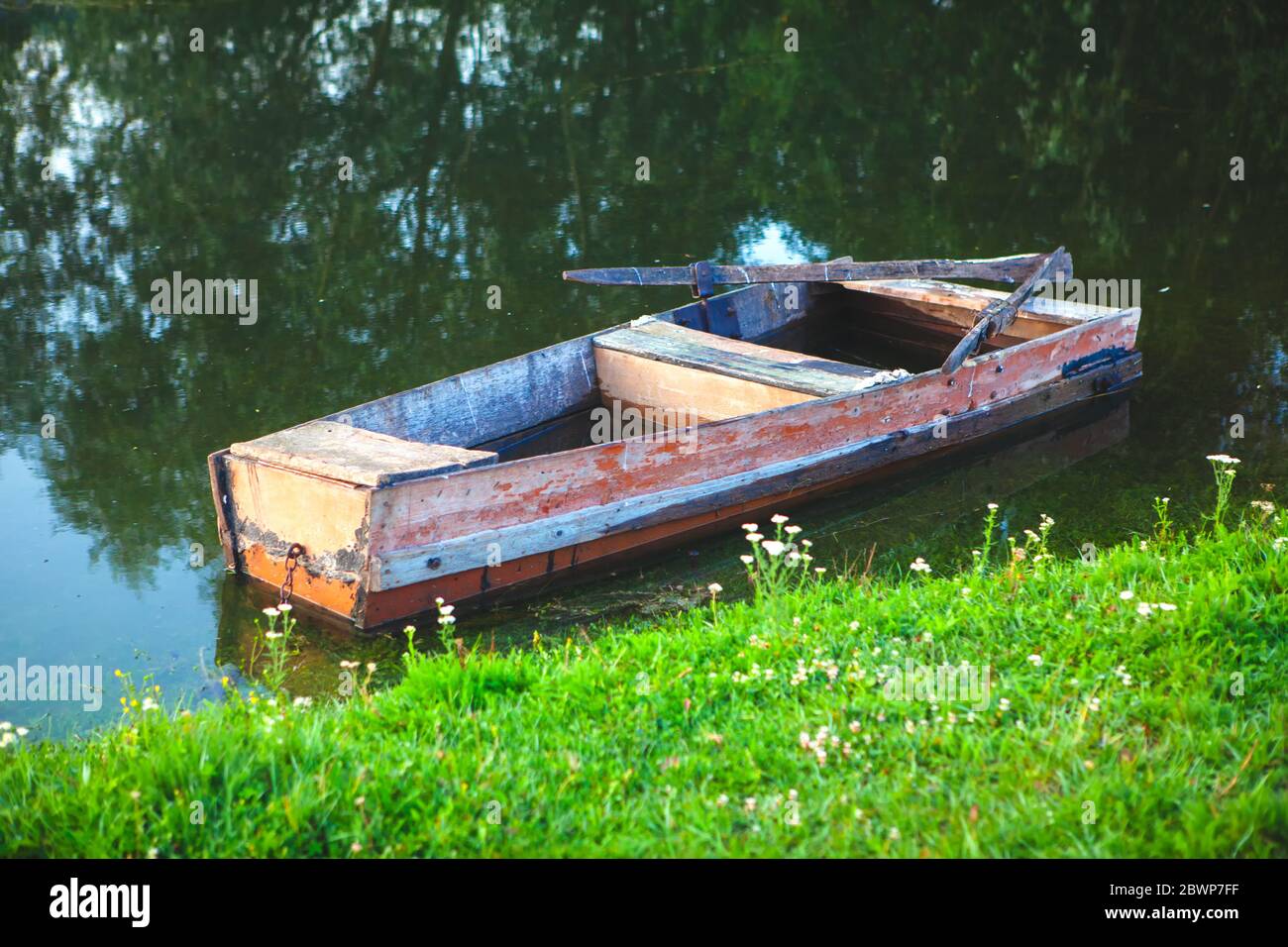 sceneric view of boat and green shore Stock Photo - Alamy