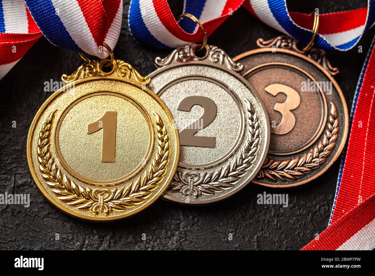Gold, silver and bronze medal with ribbons. Award for first, second and ...