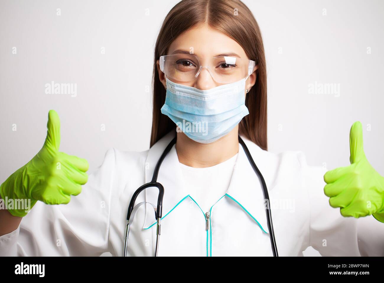Young doctor shows in gloves the symbol of good Stock Photo - Alamy