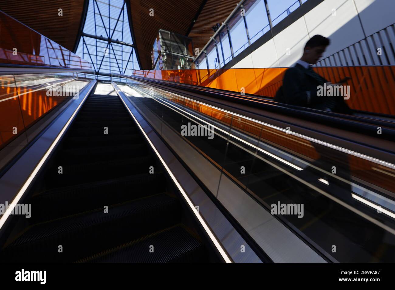 School Kid on smart phone on escalator travelling on Sydney Metro ...