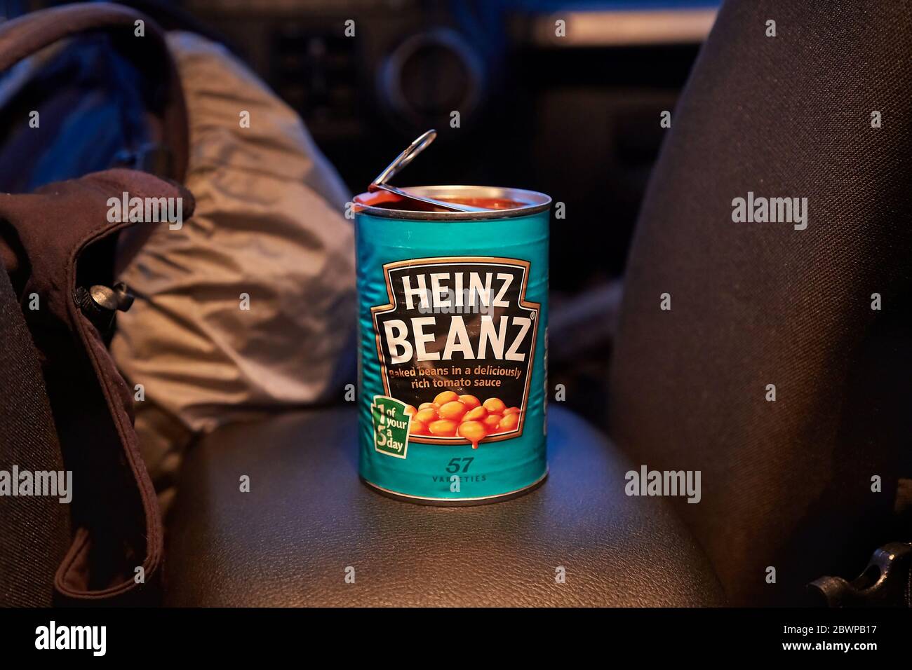Can of beans open on the back seat of a car Stock Photo - Alamy
