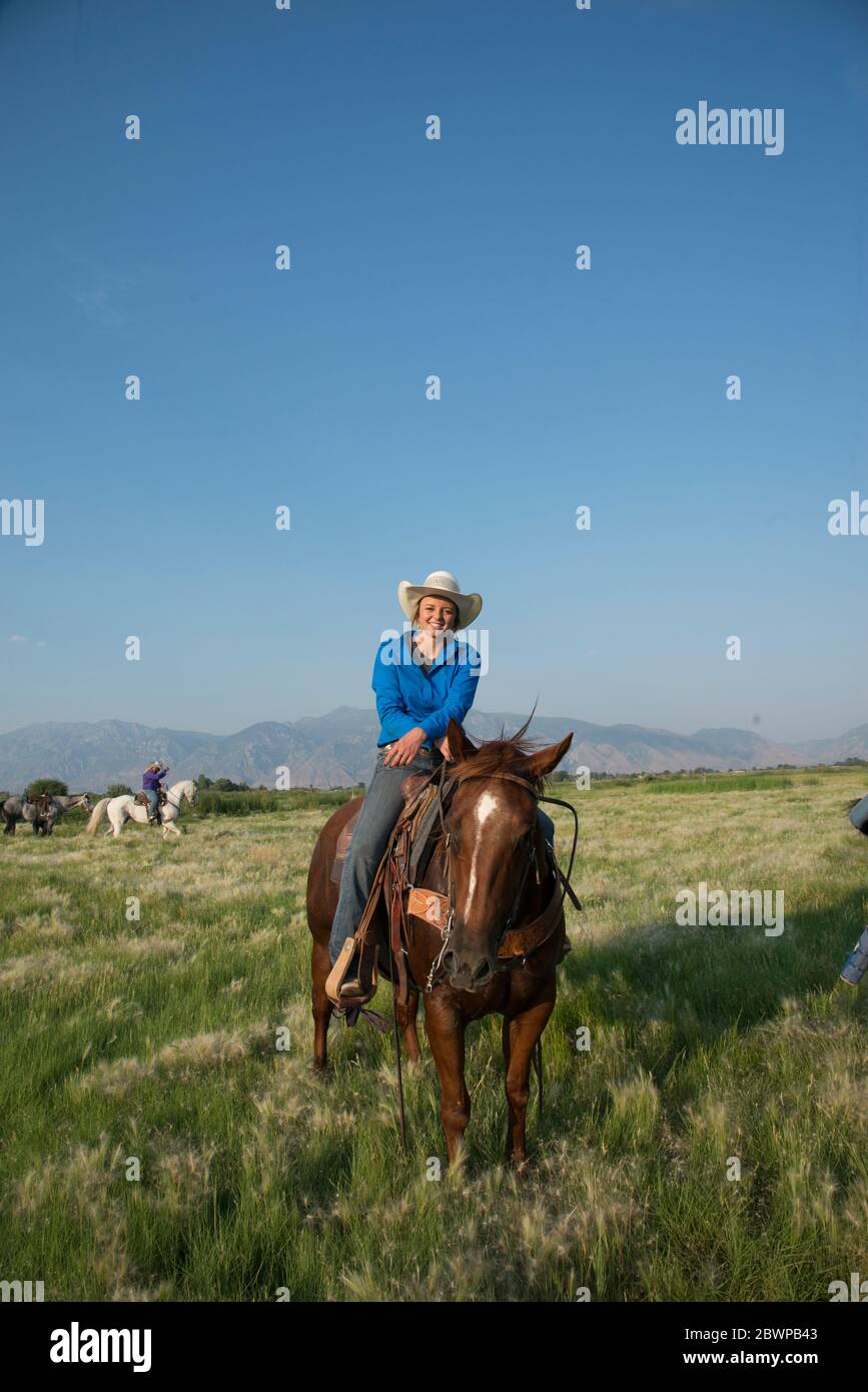 Cowgirl on Horseback on Ranch Stock Photo - Alamy