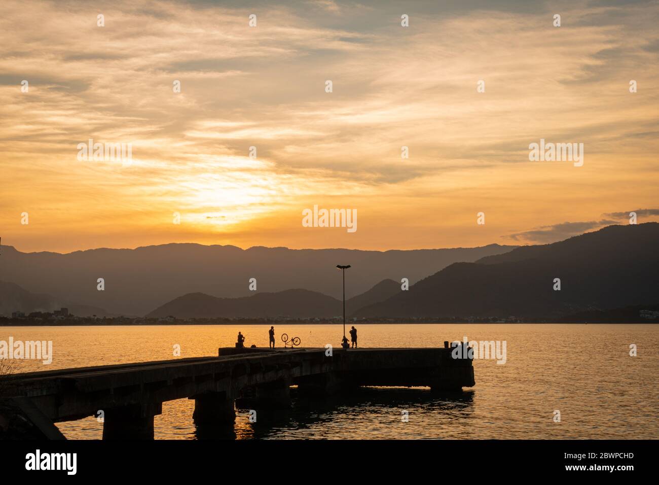Sunset sky over the pier and the beach Stock Photo - Alamy