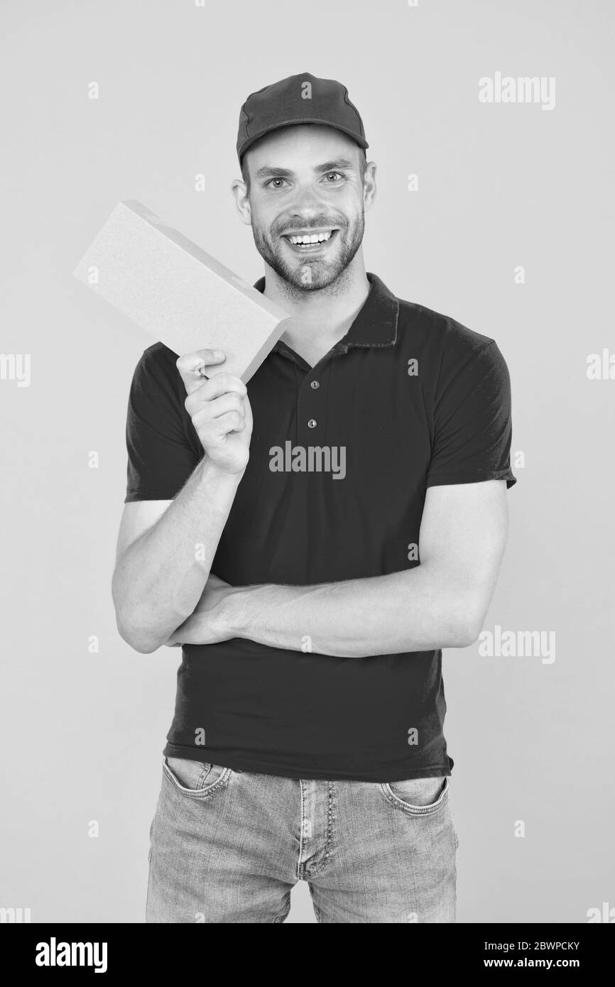 Postman delivery worker. Man red cap yellow background. Delivering ...