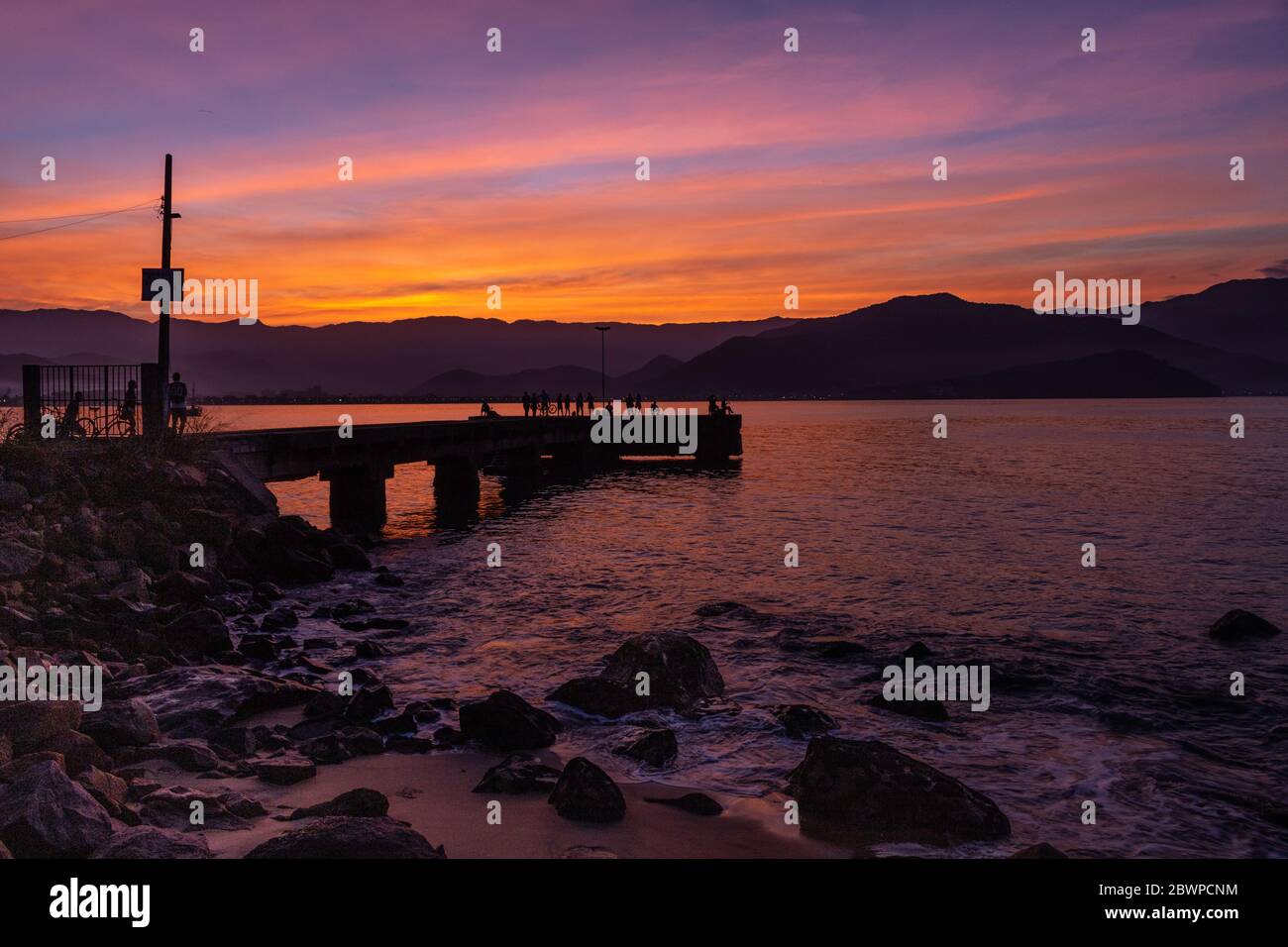Sunset sky over the pier and the beach Stock Photo - Alamy