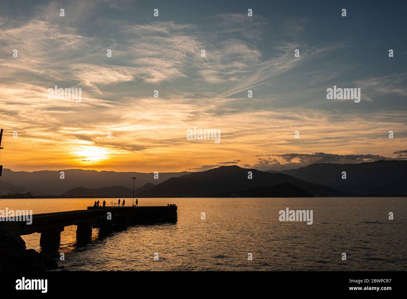 Sunset sky over the pier and the beach Stock Photo - Alamy