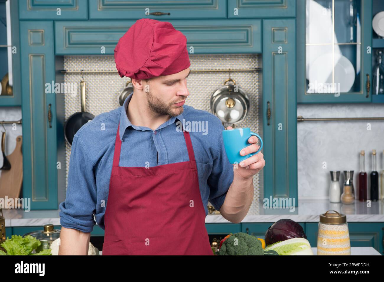 But first coffee. Man with holds coffee cup. Cook stands near table ...