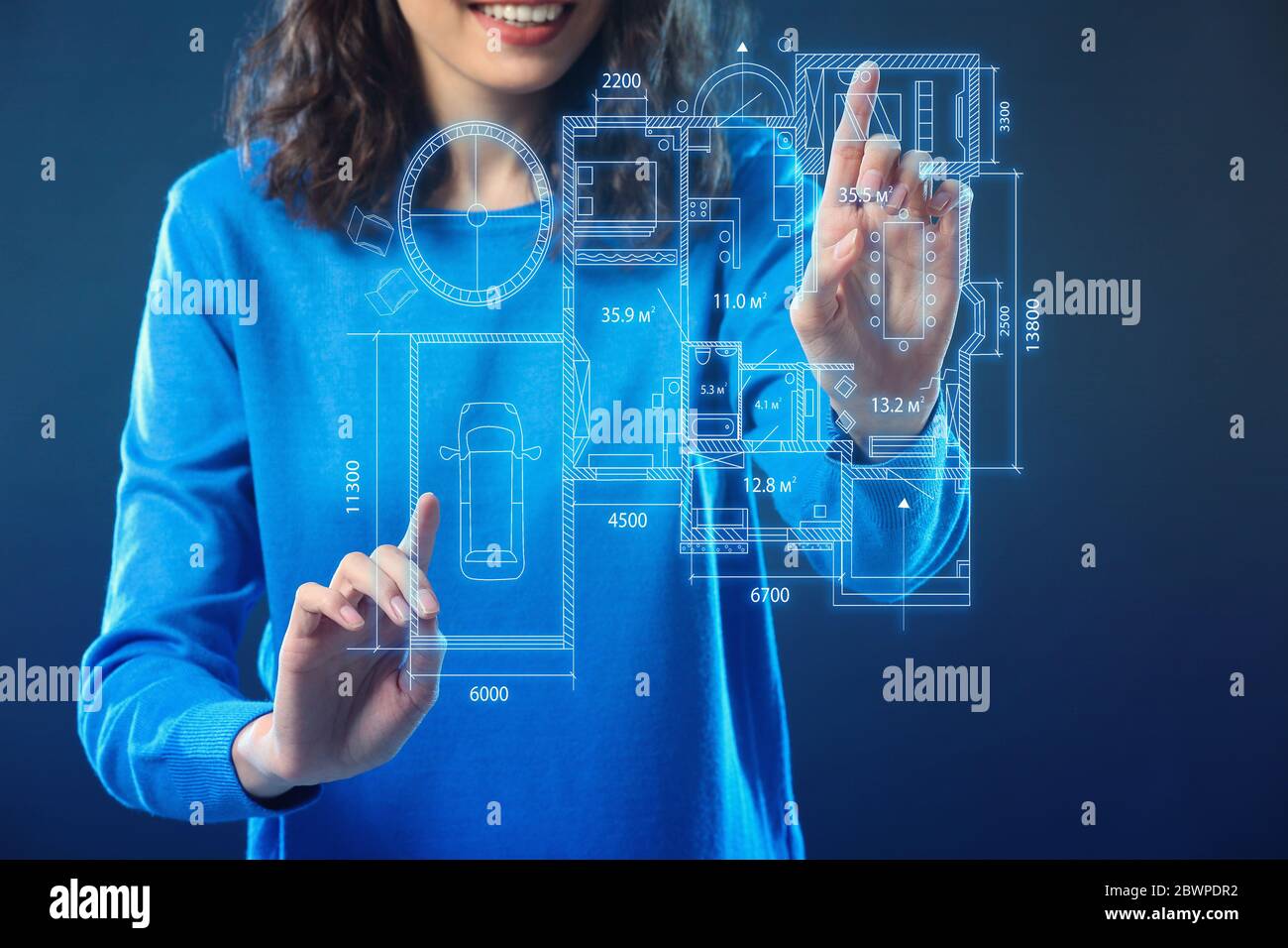 Female architect with virtual plan of building on dark background Stock ...