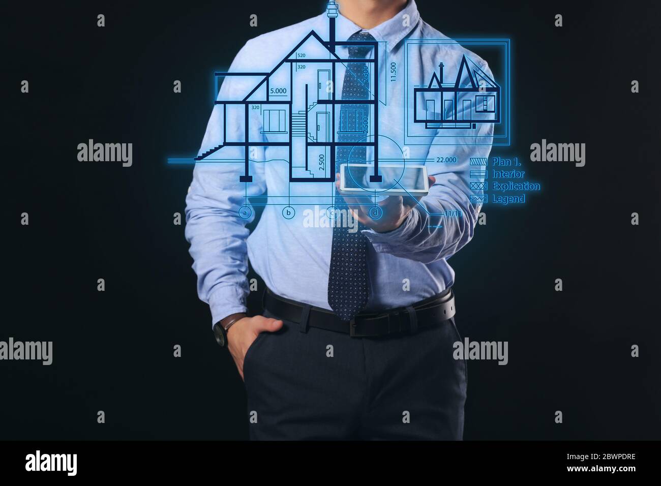 Male architect with virtual model of building on dark background Stock ...