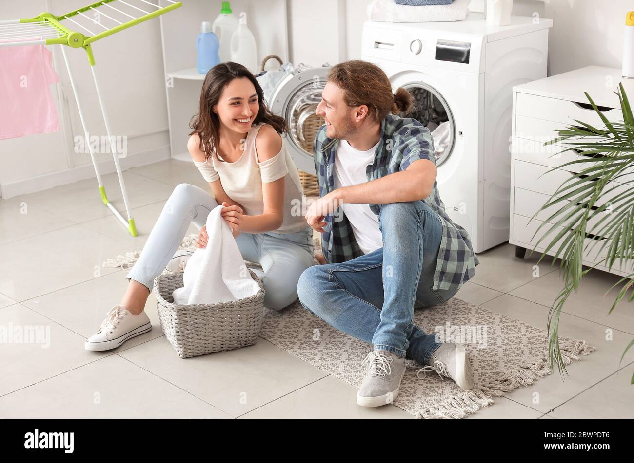 Couple doing laundry hi-res stock photography and images - Alamy