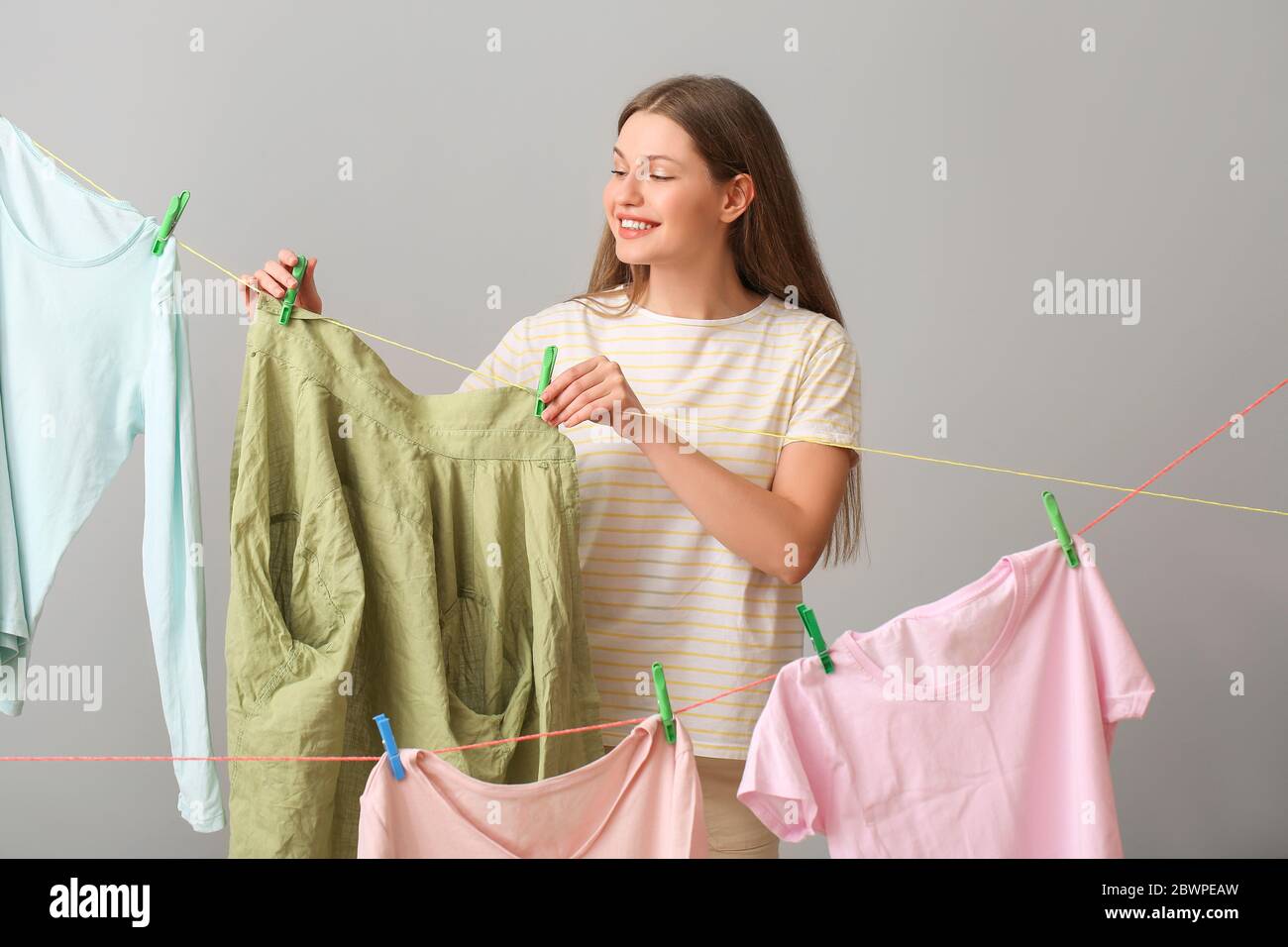 Girl hanging washing line hi-res stock photography and images - Alamy