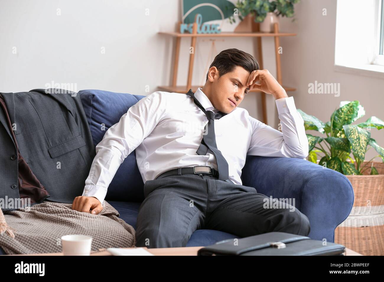 Young businessman resting at home after long working day Stock Photo ...