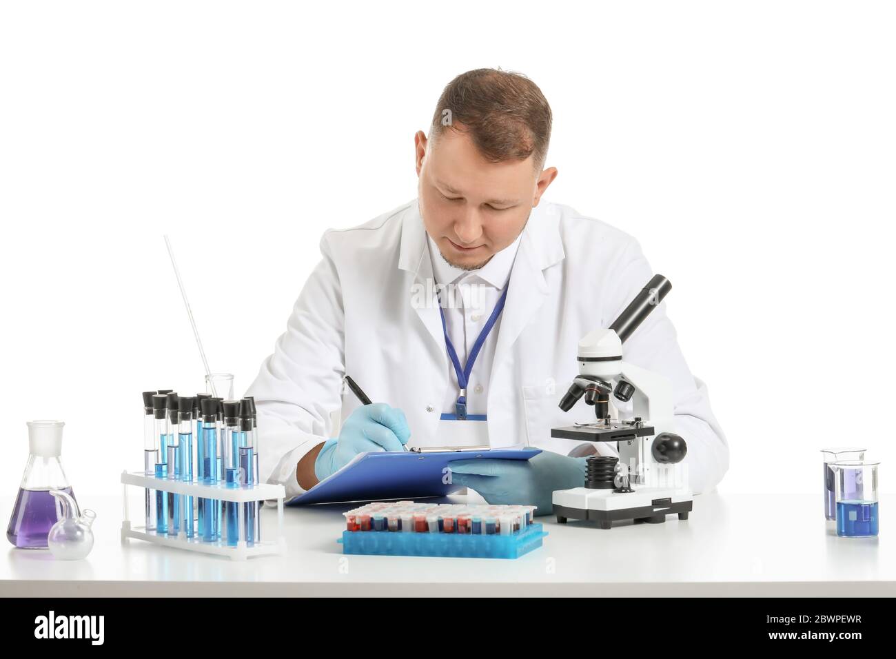 Scientist working with microscope on white background Stock Photo - Alamy
