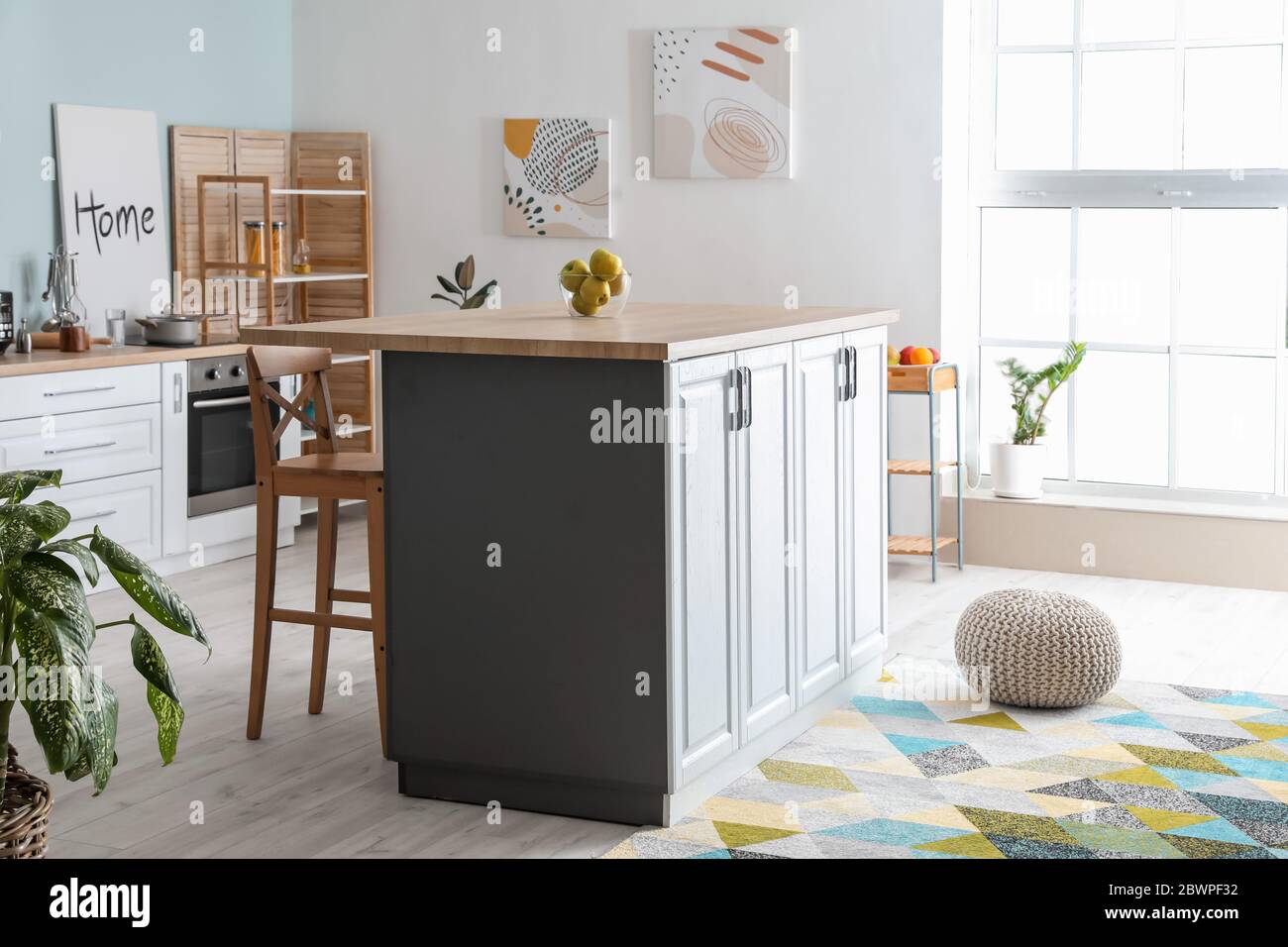 Interior of modern kitchen with stylish table Stock Photo - Alamy