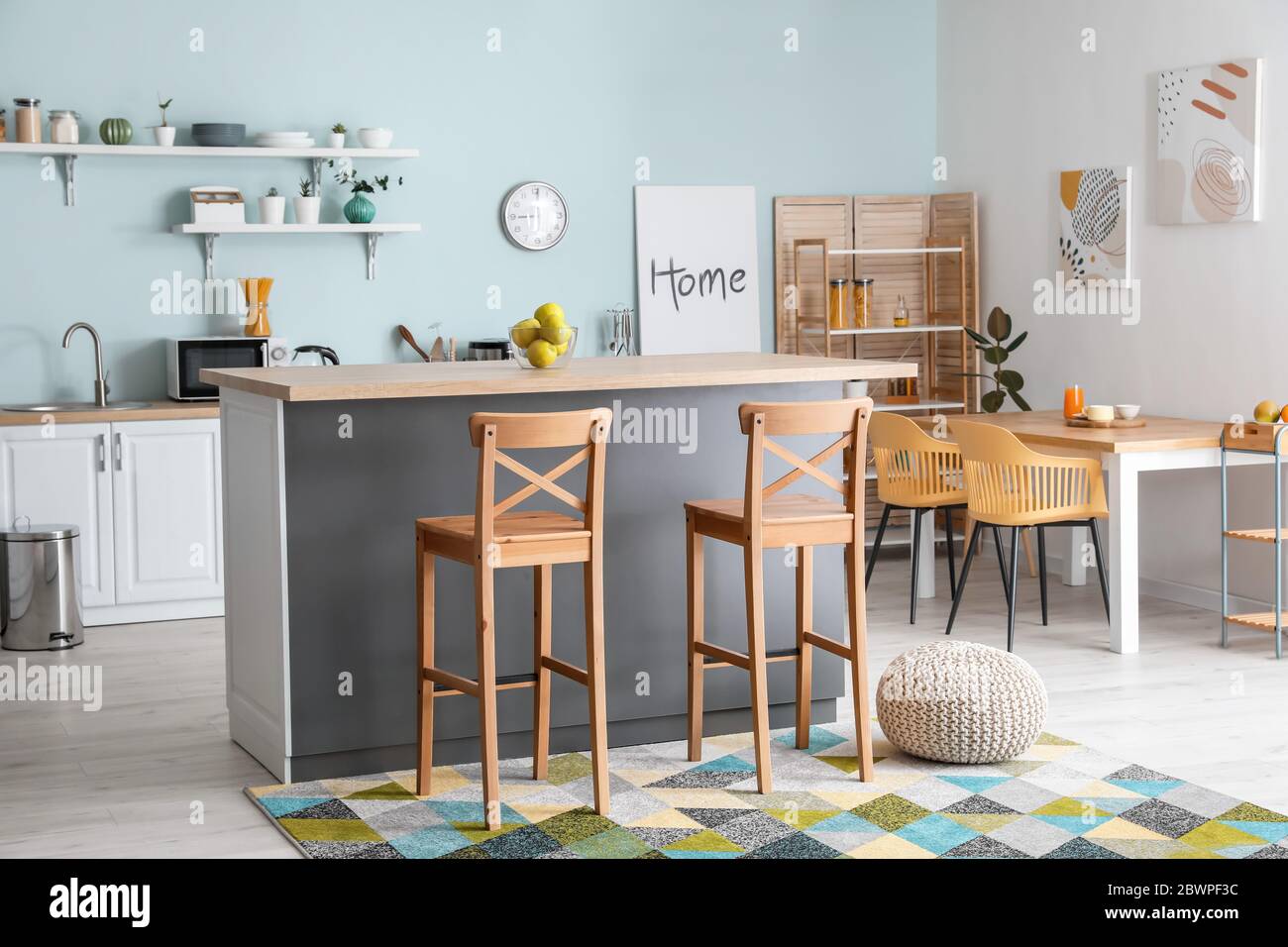 Interior of modern kitchen with stylish table Stock Photo - Alamy