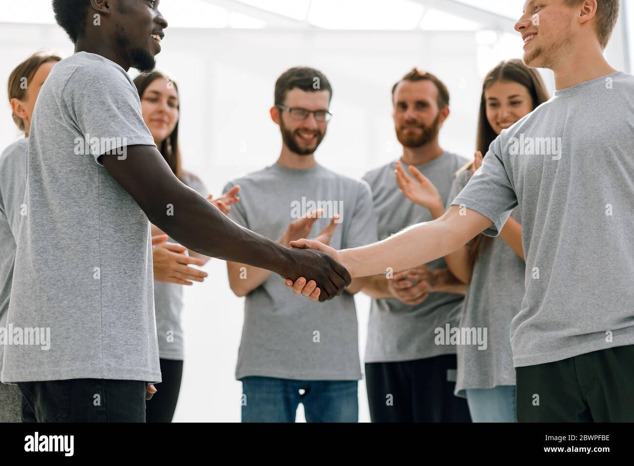 close up. strong handshake of two students of different nationalities ...