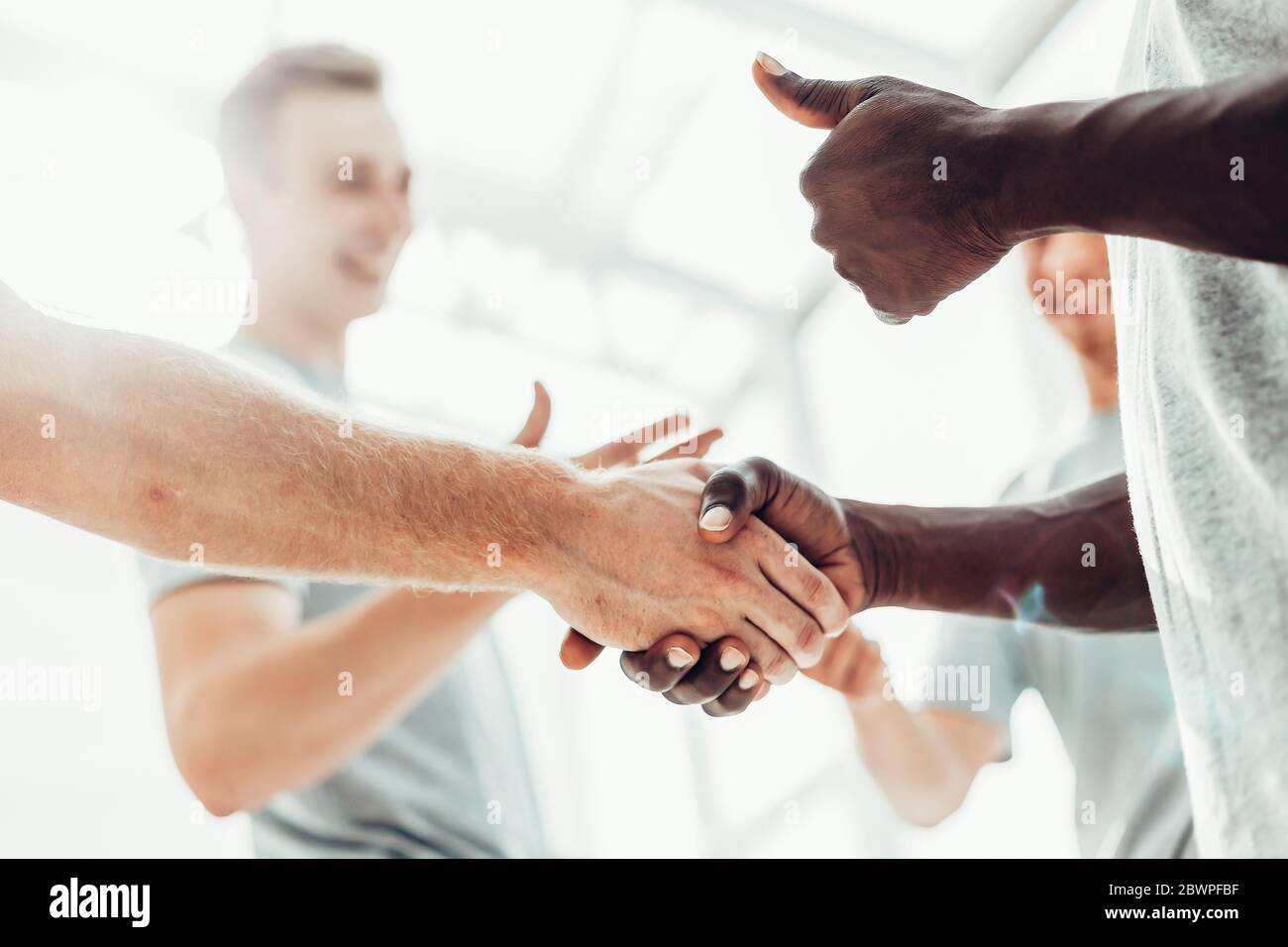 close up. two young like-minded people shaking hands Stock Photo - Alamy