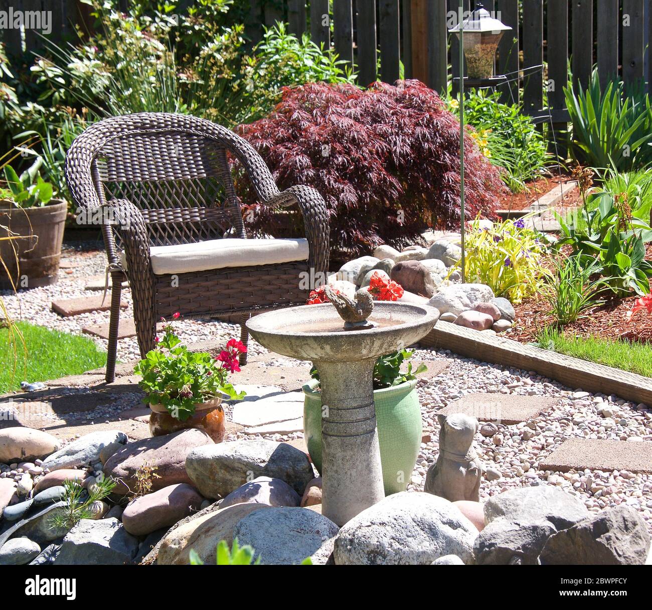 Backyard landscape with comfort sitting by pond Stock Photo - Alamy