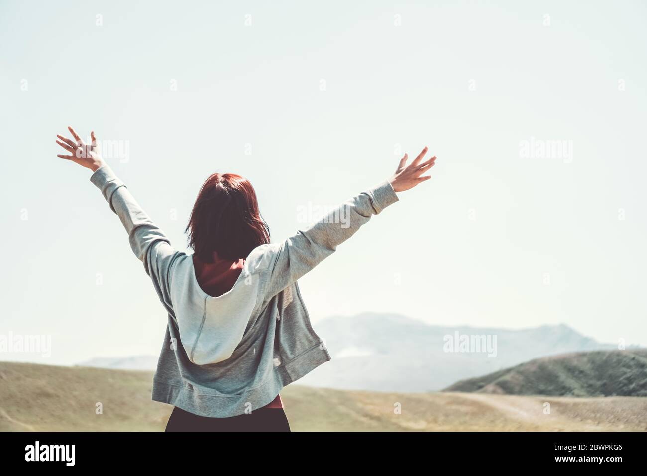 Woman rise hands up to sky freedom concept with blue sky and summer ...