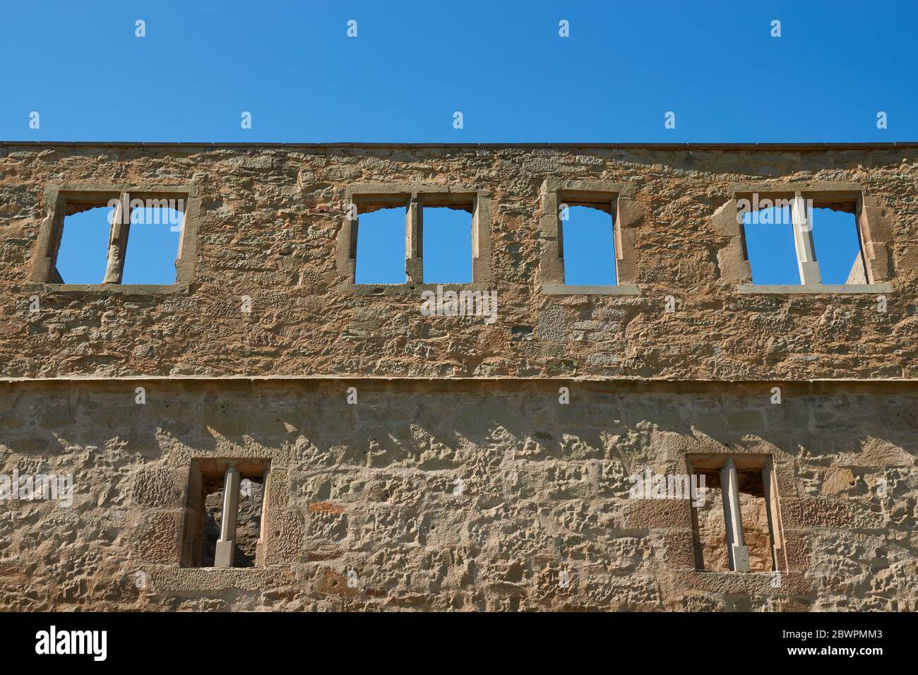 Facade of a brown castle wall, many beautiful windows to see, blue ...