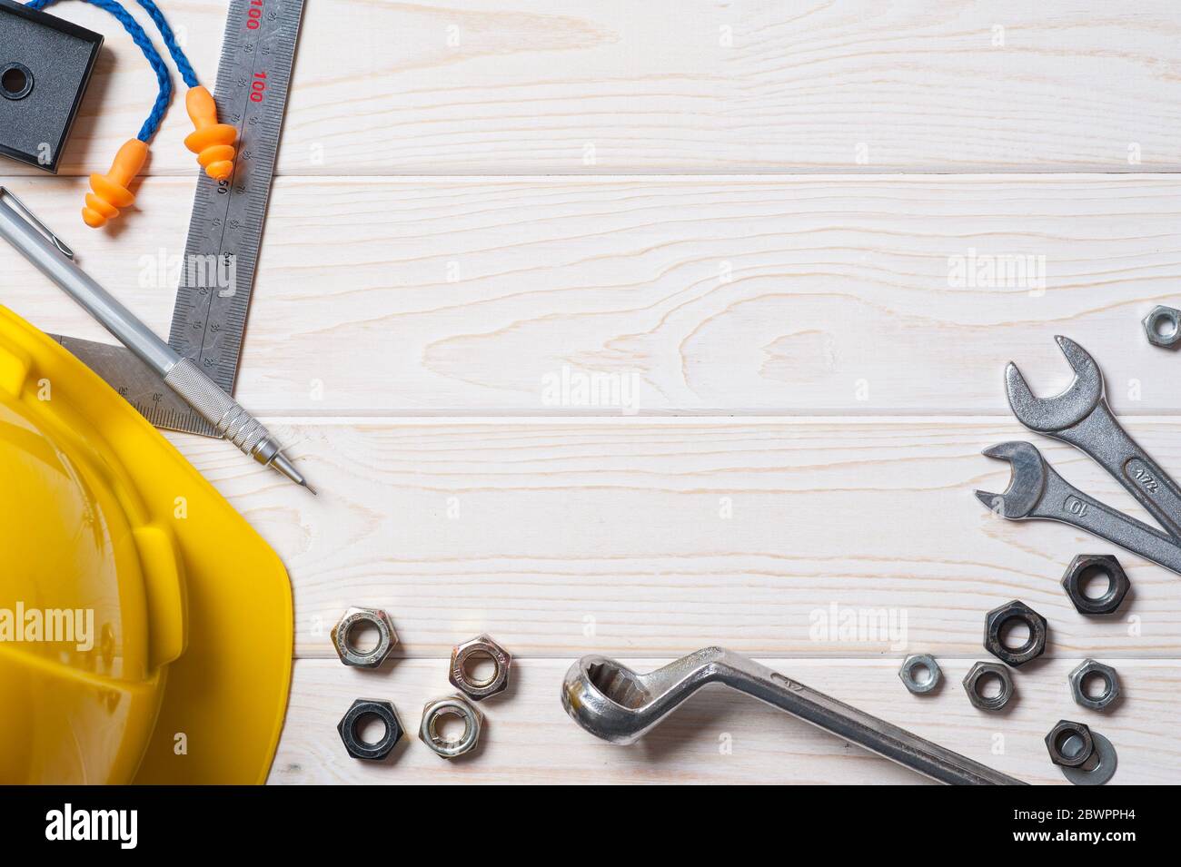 flat lay of industrial objects on white wooden plank with space for ...