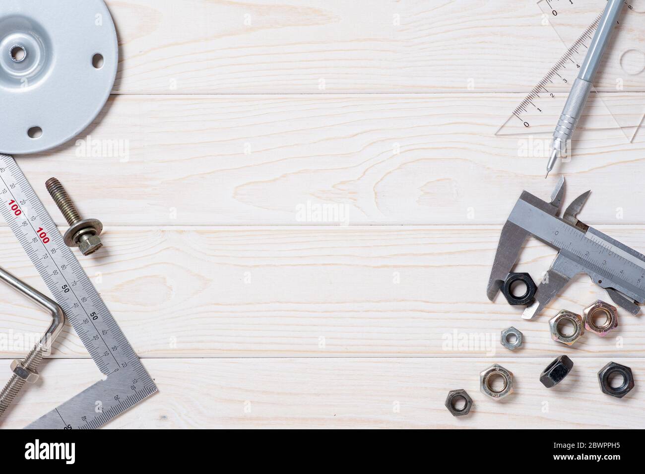 flat lay of industrial objects on white wooden plank with space for ...