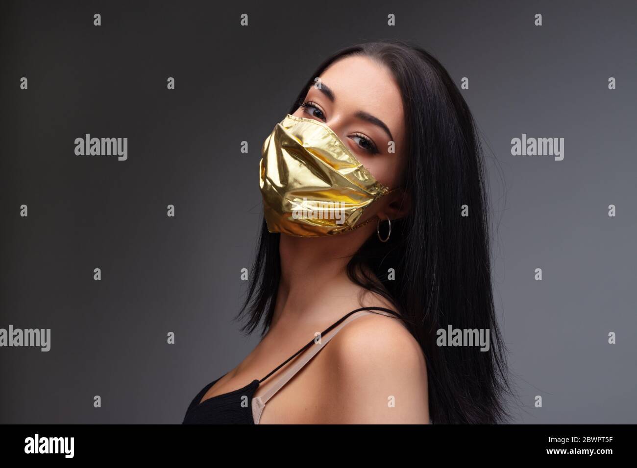 woman wearing a golden face mask - concept of surgical masks price rise ...