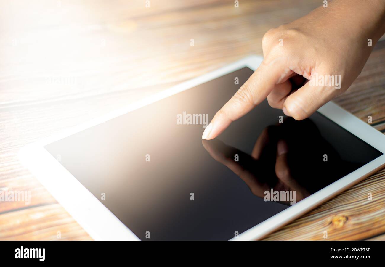 Female hand touching screen on modern digital tablet similar to ipad ...