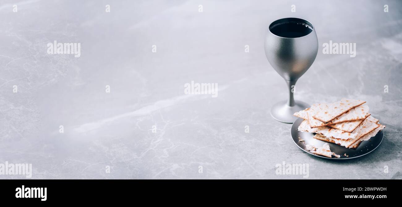 Matzos unleavened bread with kiddush cup of wine. Jewish Pesah holiday ...