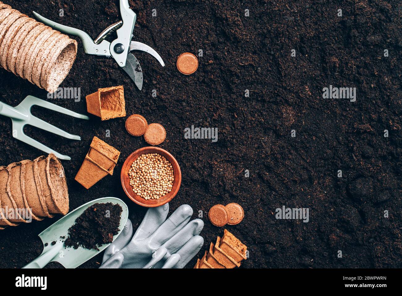 Gardening tools, seeds, pruner, rake, shovel, biodegradable pots over ...