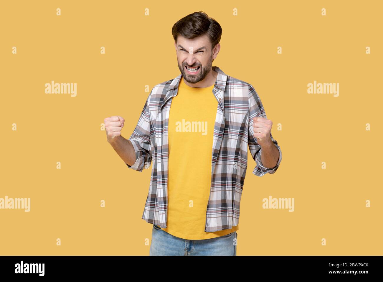 Young angry man raising his hands in fists Stock Photo - Alamy