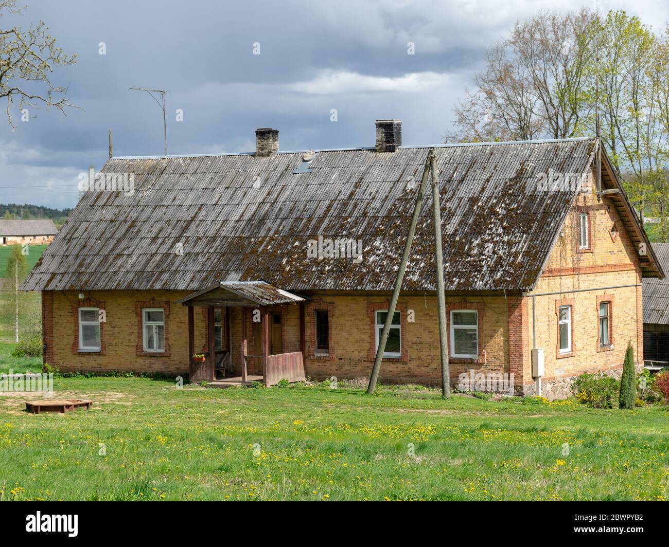 landscape with a traditional and simple country house, beautiful spring ...