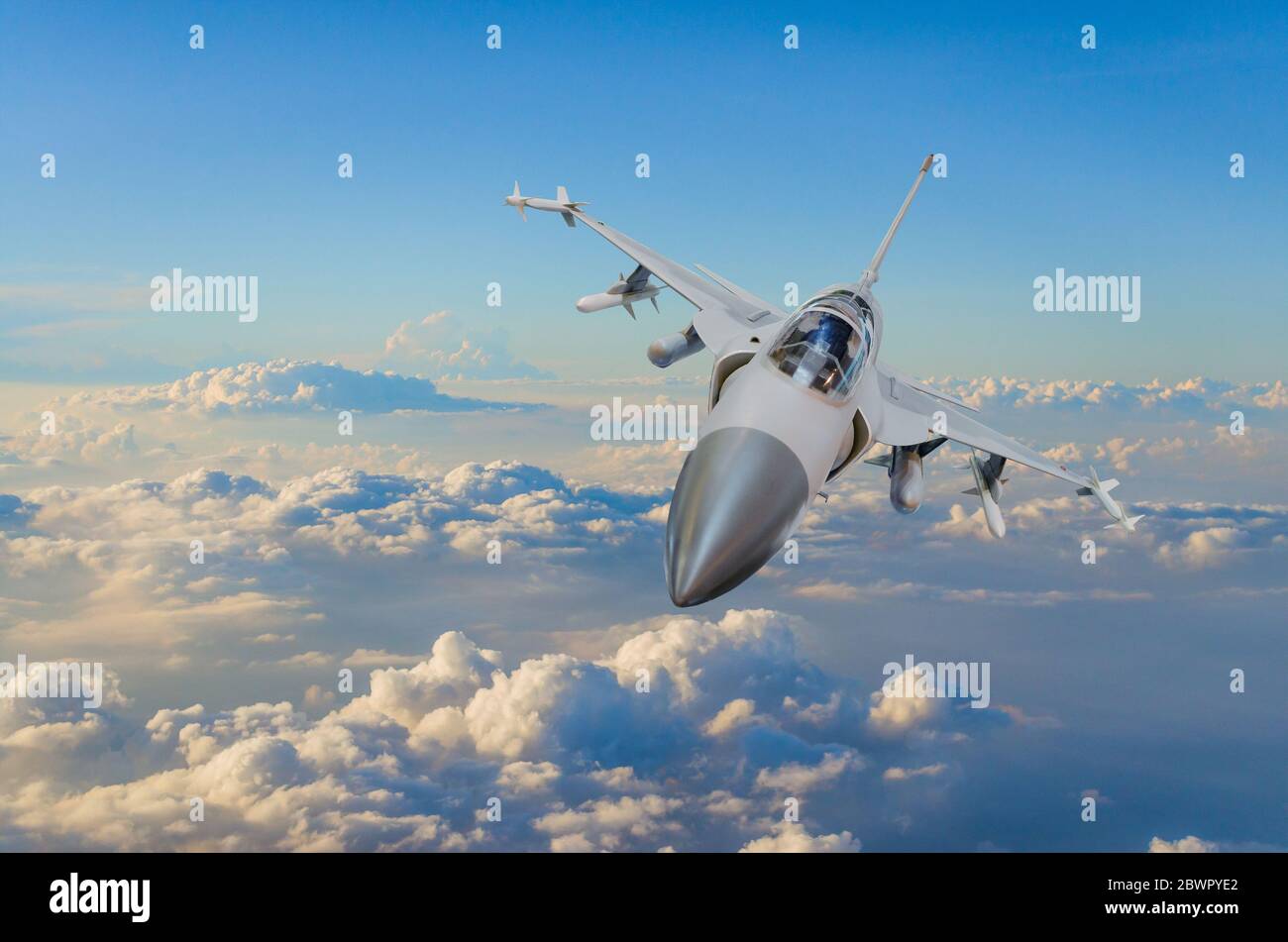 Military fighter jet against a blue sky with a backlight from below ...