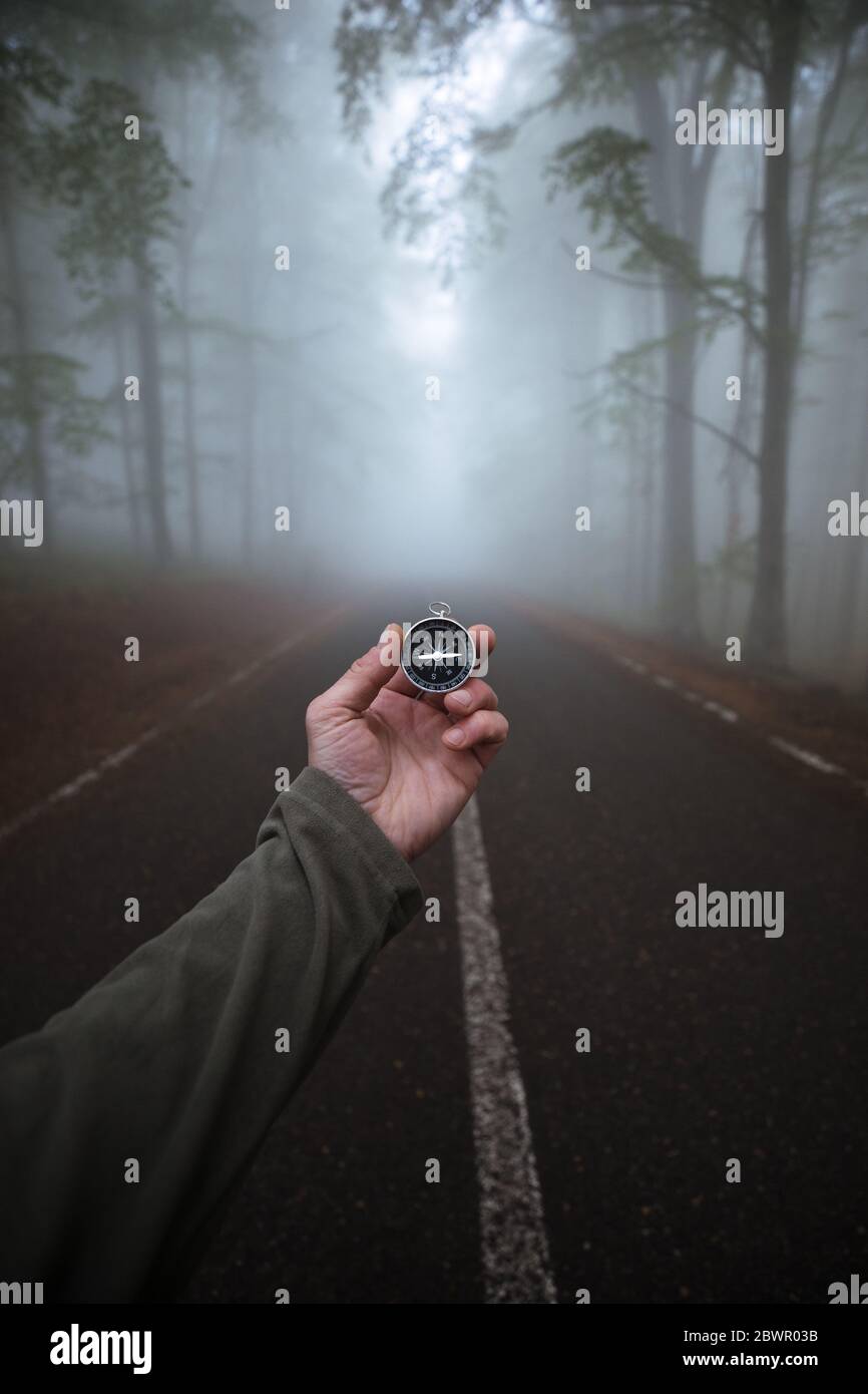 Traveler holding a compass. Hiker searching the right direction in the ...