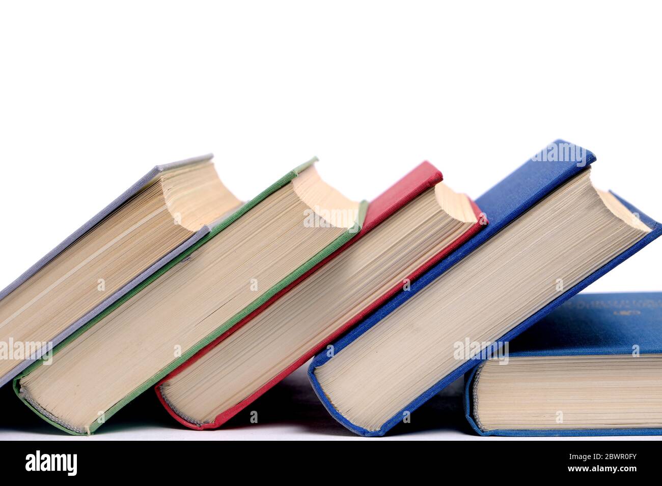 Stack of scattered books on a white background Stock Photo - Alamy