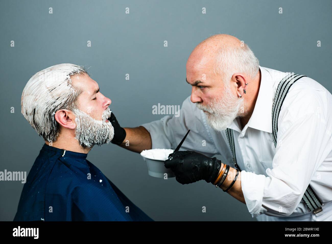 Process of dyeing hair for man at beauty salon, male closeup portrait ...
