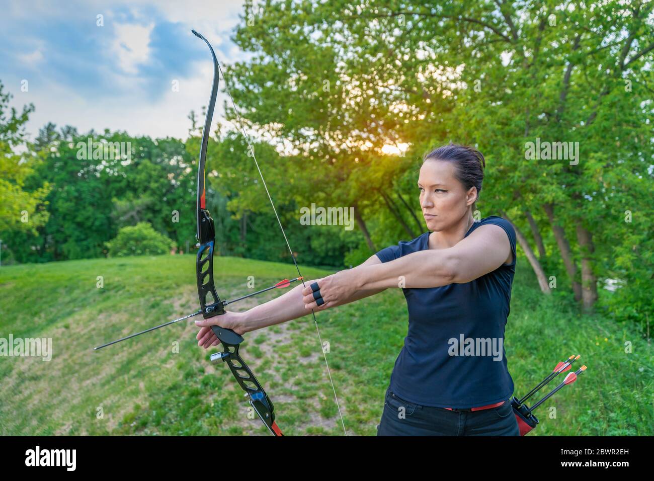 stretching an arrow in a bow during archery in nature Stock Photo - Alamy