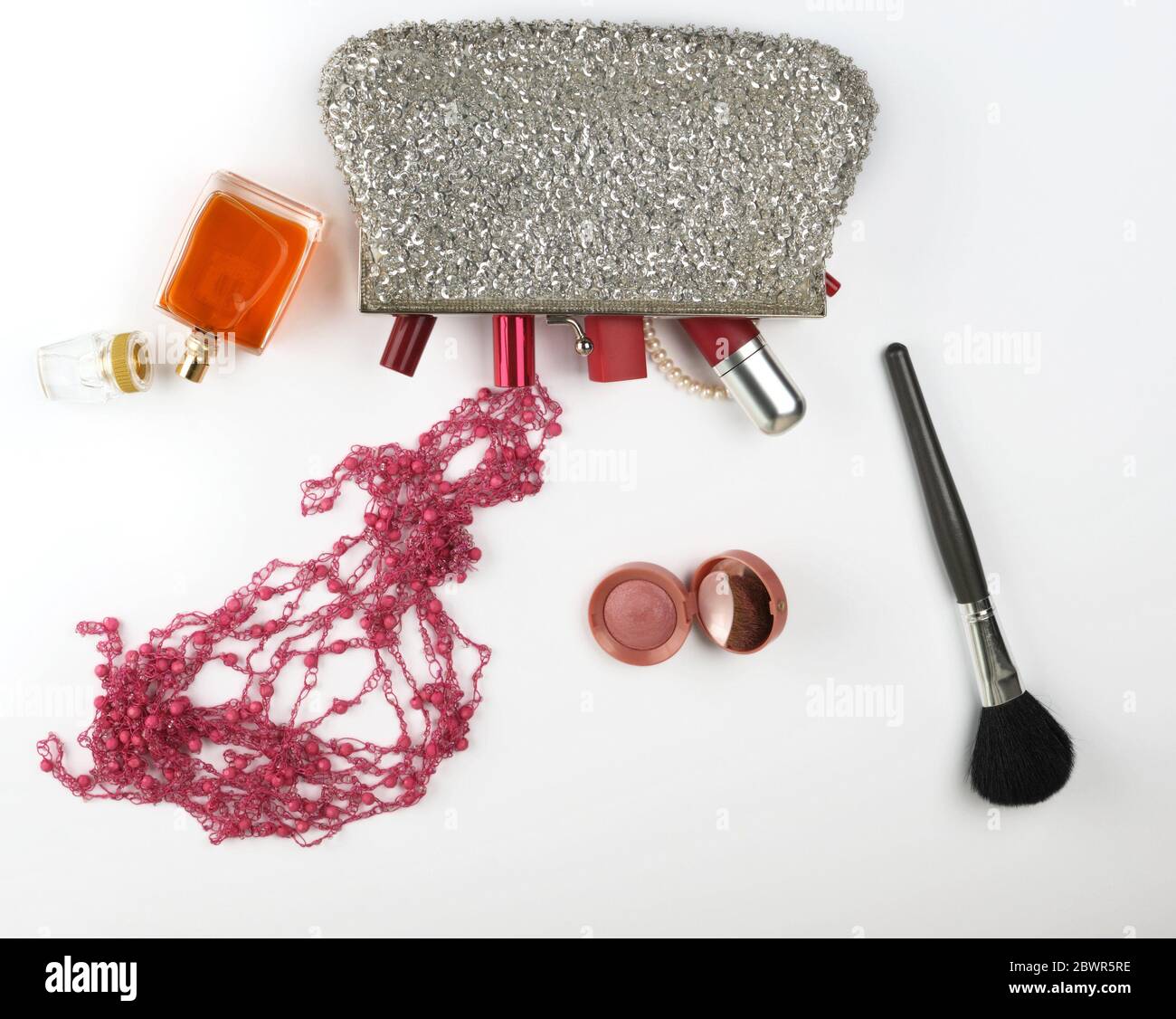 open silver cosmetic bag and women's cosmetics and perfumes, red ...