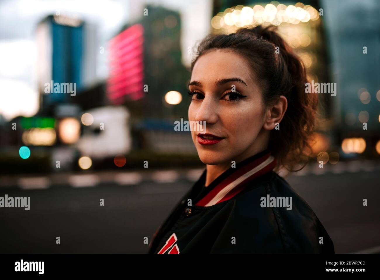 Beautiful spanish woman listening to music with earphones and smart ...