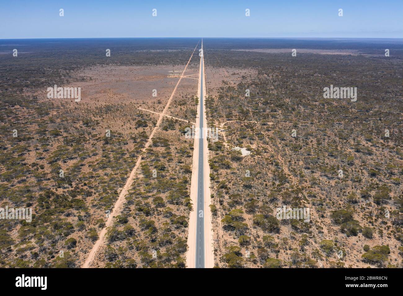 An elevated view of a long straight road in the West Australian outback ...