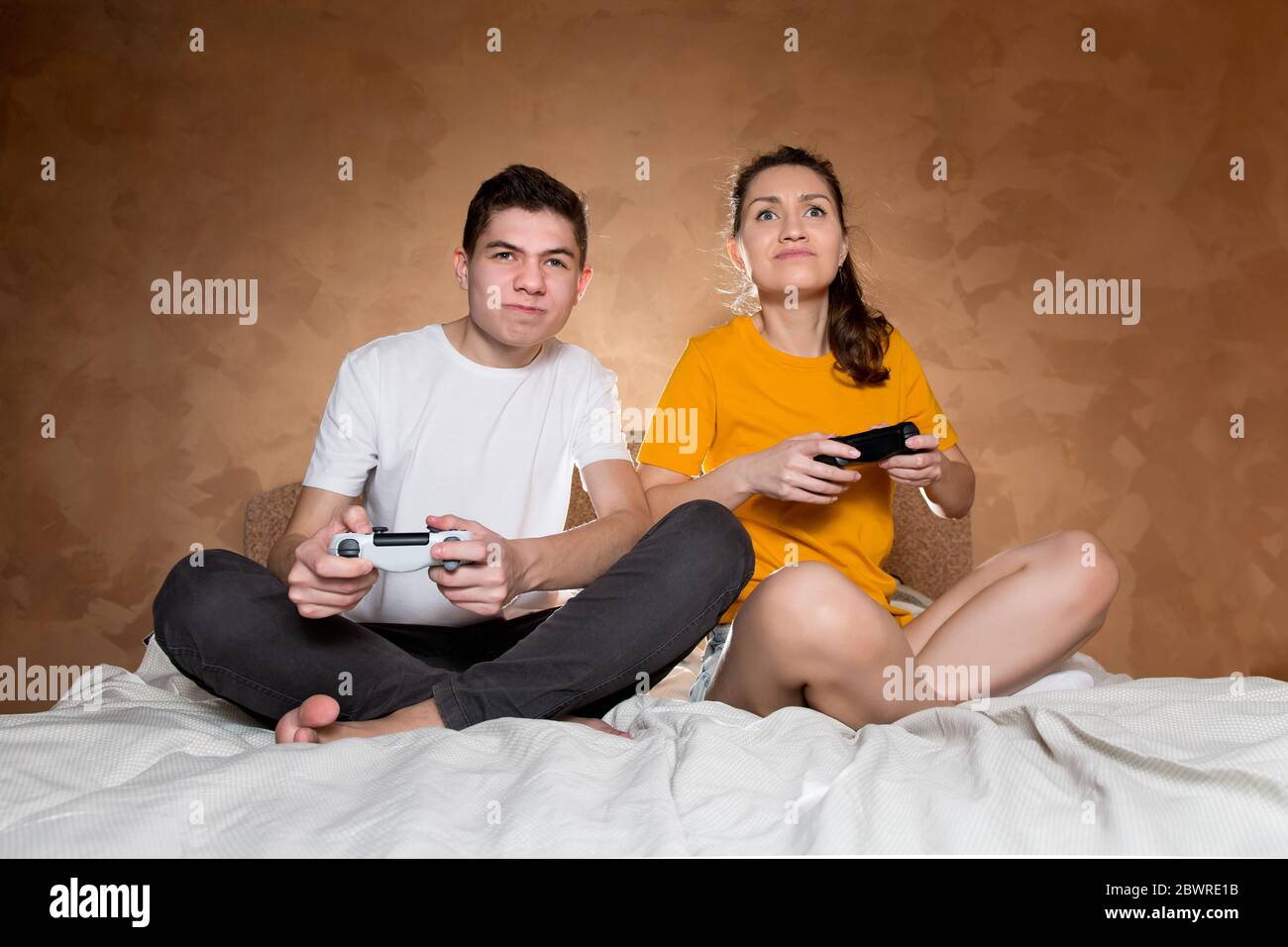 Brother and sister fight in a video game on a game console using ...