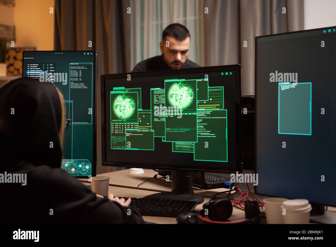 Back view of female hacker writing a malicious malware and cyber ...