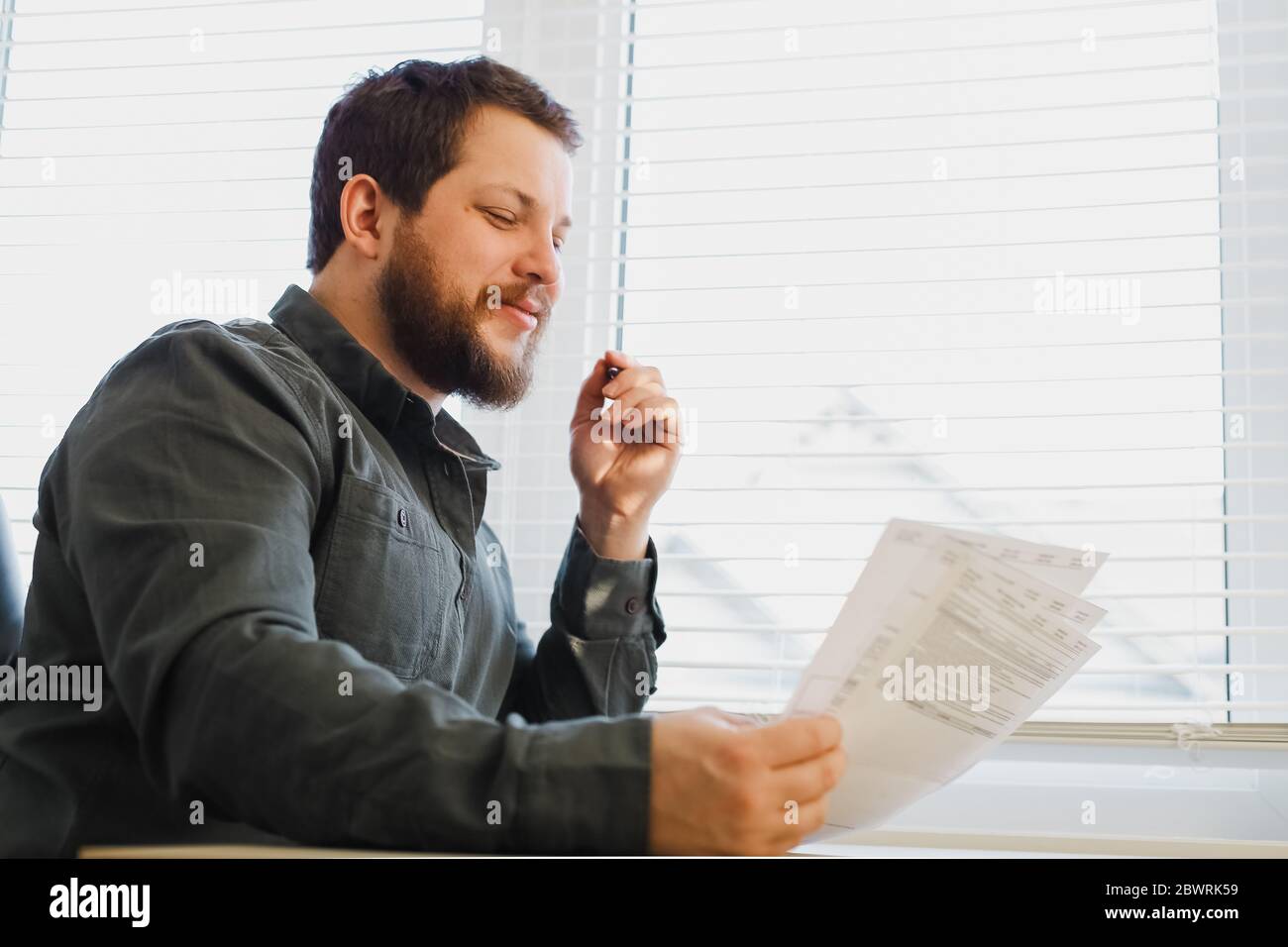 Enterpreneur filling documents at cabinet, holding papers and pen Stock ...