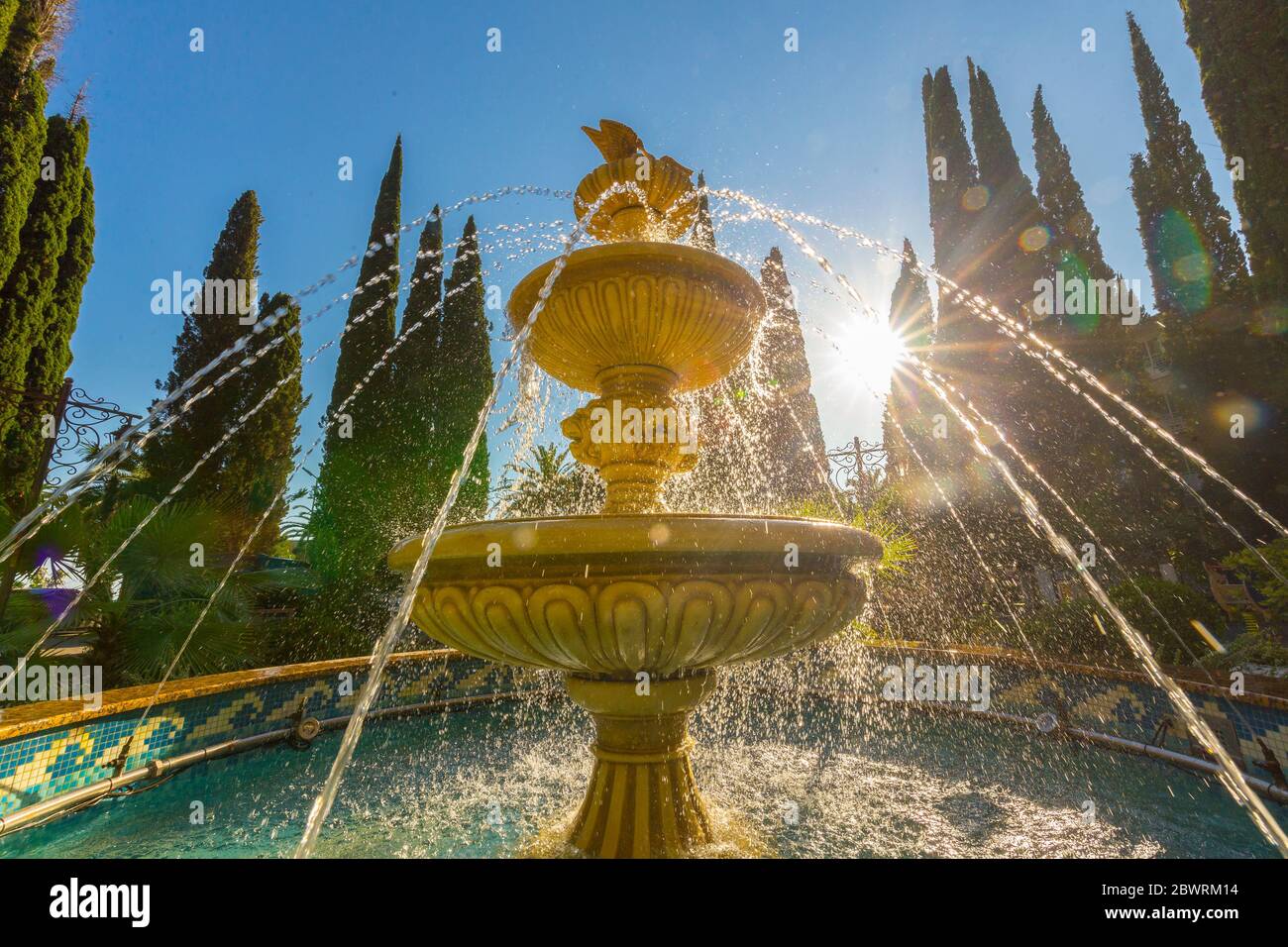 Scene with fountain and water jets spurt through the sun beams Stock ...