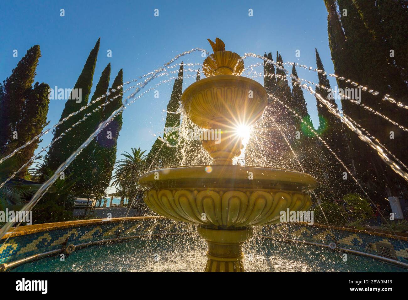 Scene with fountain and water jets spurt through the sun beams Stock ...