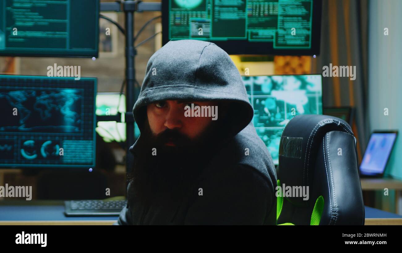 Dangerous hacker wearing a hoodies and looking into the camera. Cyber ...