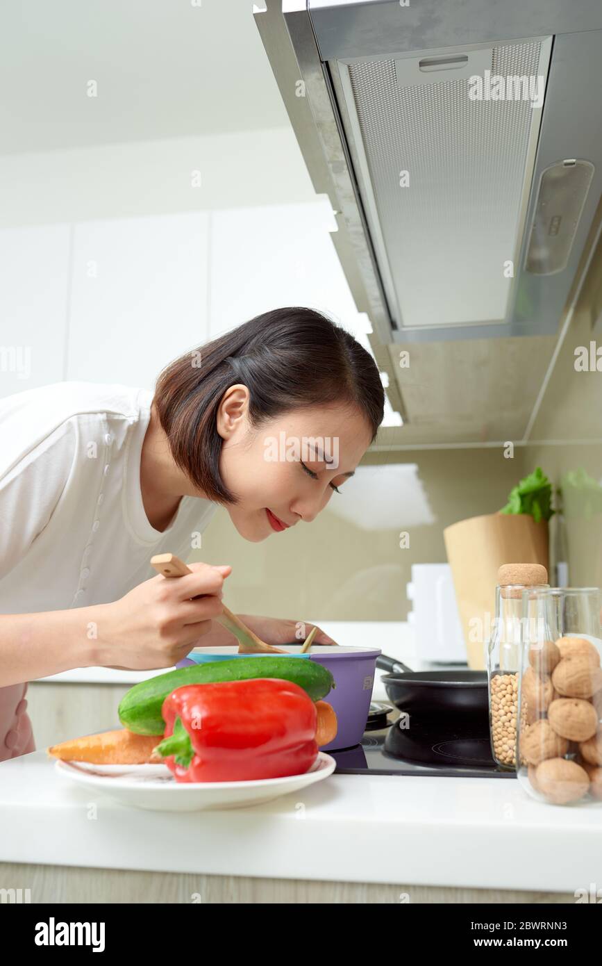 Young Woman Cooking in the kitchen. Healthy Food. Dieting Concept ...