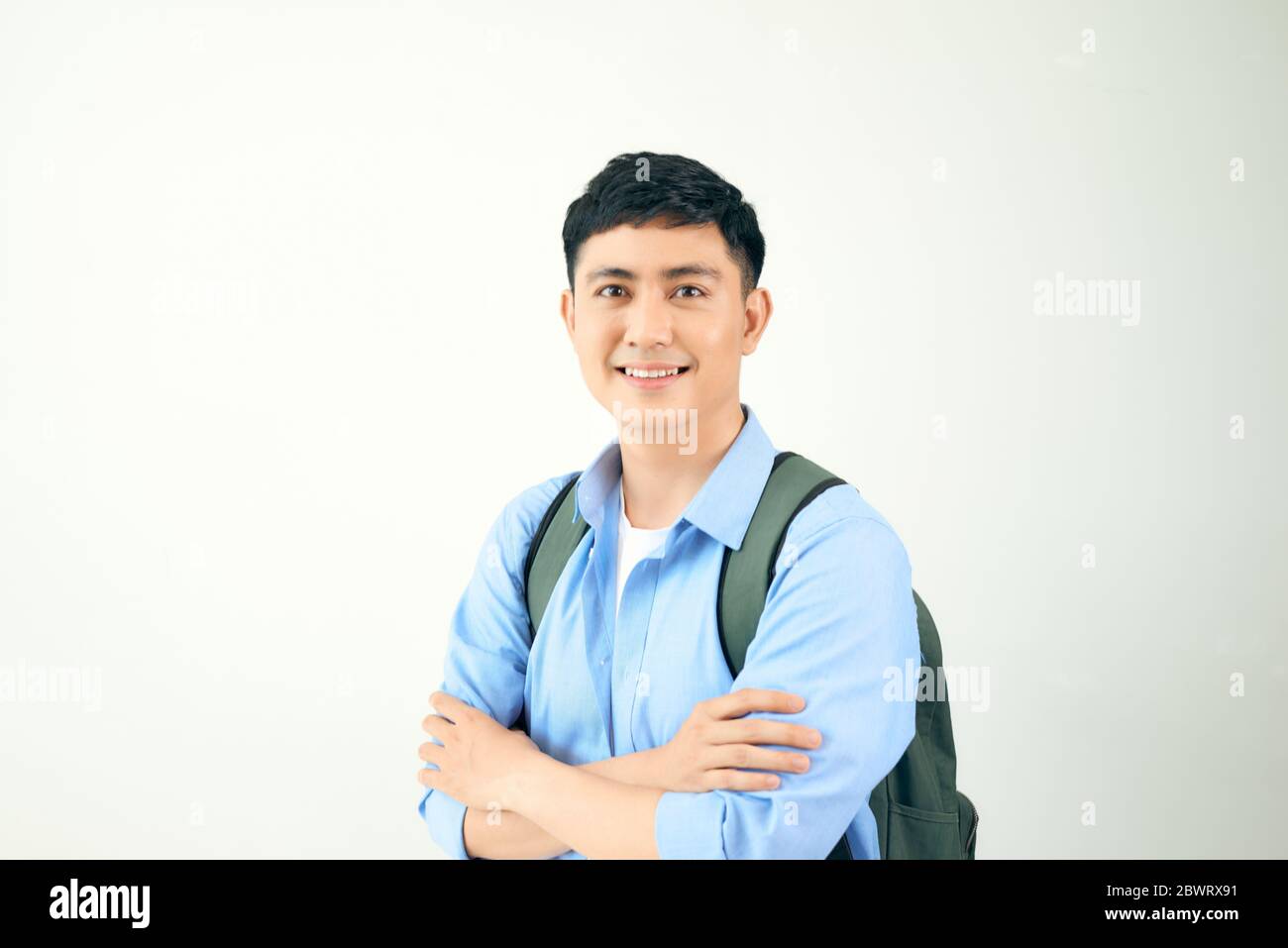 Handsome young man smiling and standing confidently on white background ...